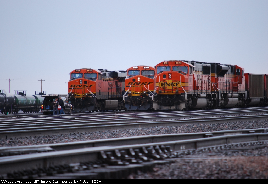BNSF 6315 with the crew getting out of the crew bus waits to roll west with a mty coal train as ...
